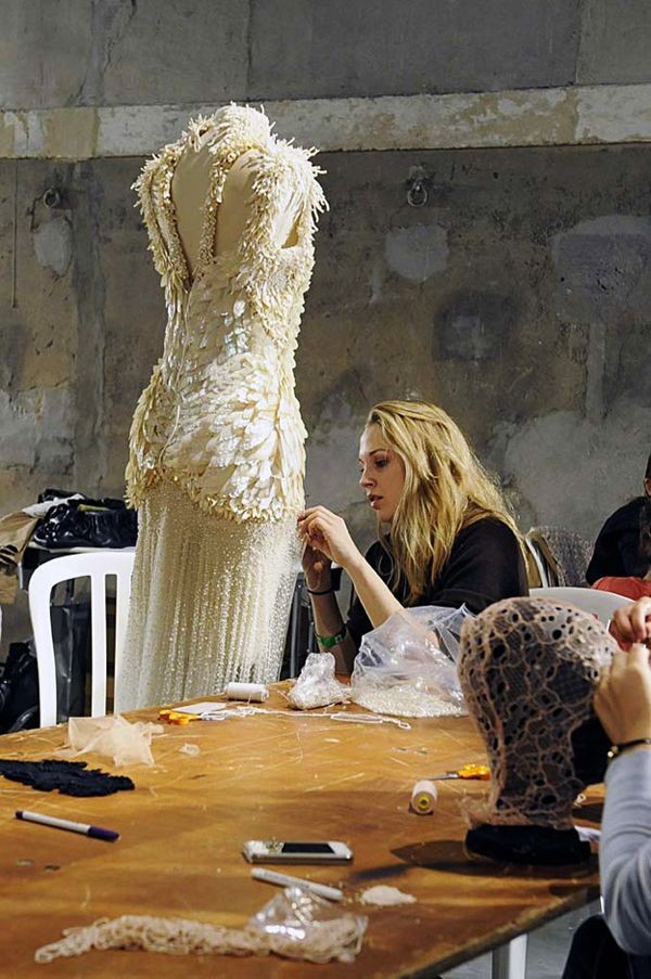 Haute Couture, the making of a dress - dressmakers hand embellishing an ...